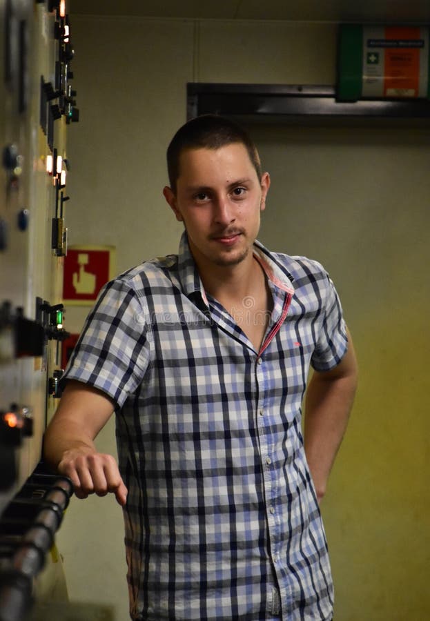 Maritime Engineer Looking at Blueprints and Standing Near Vessel. Stock ...