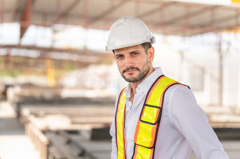 Portrait of a Young Engineer Man in Hardhat at a Construction Site ...