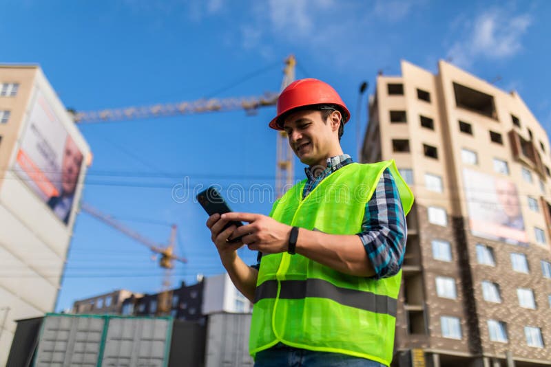 Portrait of Young Engineer Man Use Phone while Standing at Construction ...