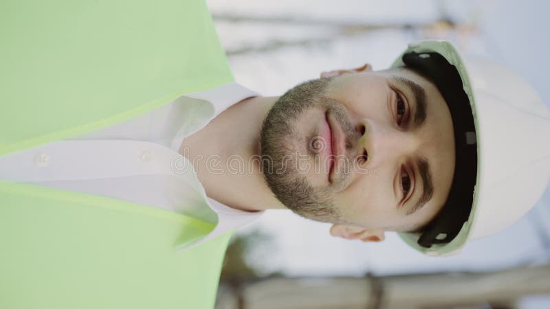 Vertical Portrait of the Young Engineer Outside. Builder in Hard Hat or ...