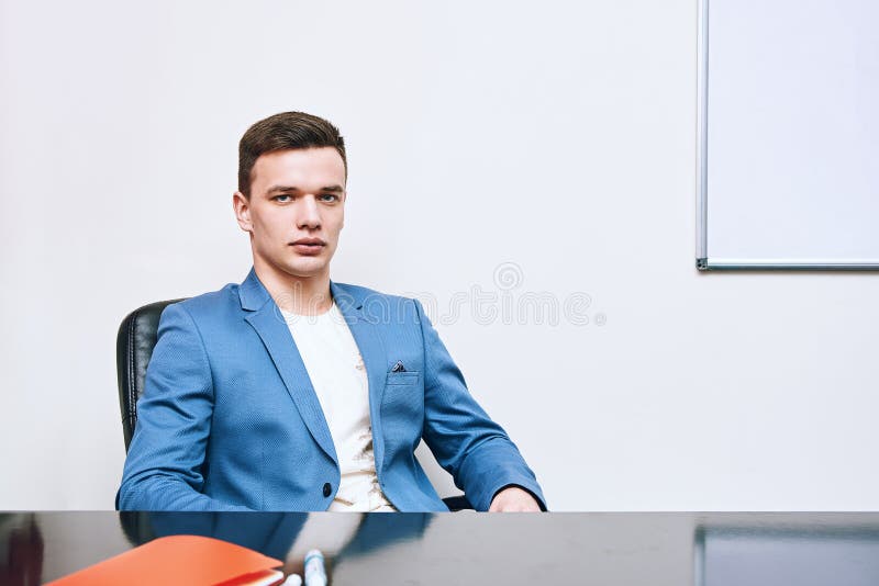 Portrait of a Young Executive in an Office at a Table in a Suit. Stock ...