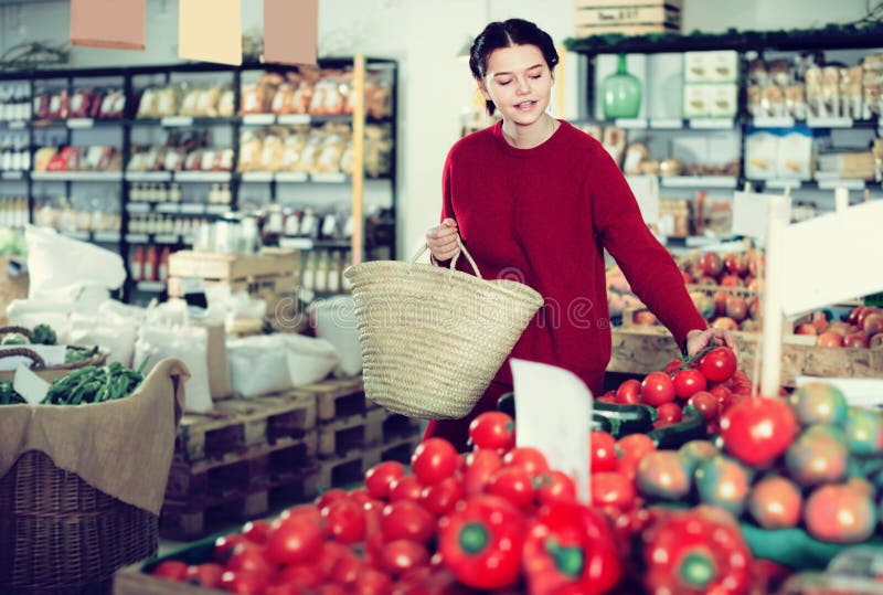 Portrait of Young Female Customer Selecting Tomatoes in Grocery Stock ...