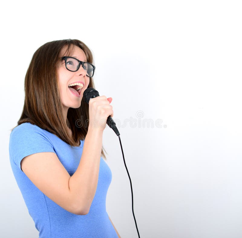 Portrait of a Young Female with Microphone Against White Background ...