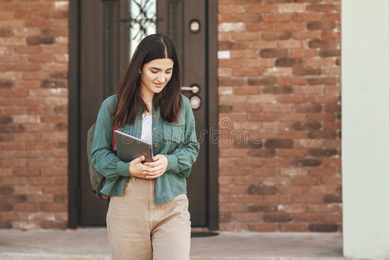 Portrait of Young Female Student with Beautiful Smile Using Tablet in ...