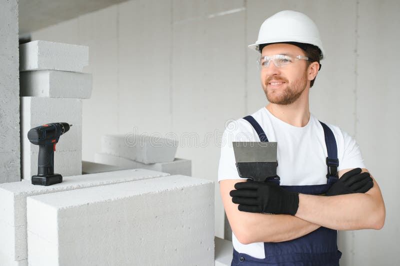 Portrait of a Young Foreman in Uniform Standing on a Construction Site ...