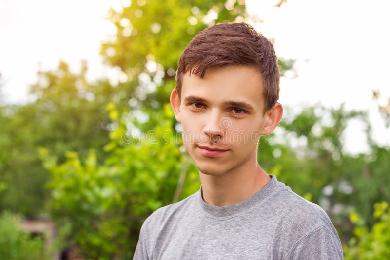 Portrait of a Young Guy on a Natural Green Background Stock Photo ...