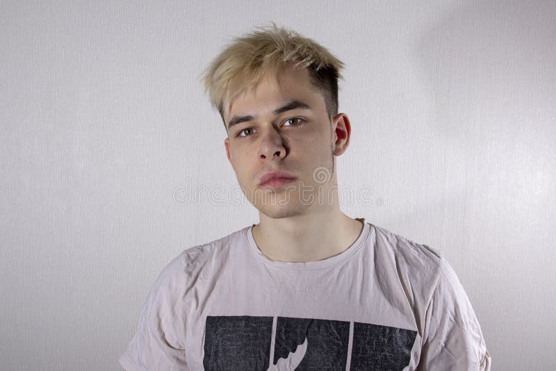 Portrait of a Young Guy in a Rumpled T-shirt on a Light Background ...