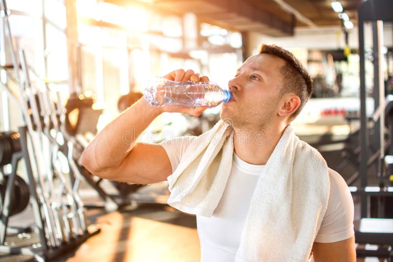 Portrait of Young Handsome Man Drinking Water at Gym. Stock Image ... Portrait of Young Handsome Man Drinking Water at Gym. Stock Image ...