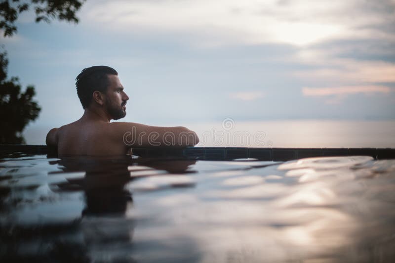 Portrait of a Man in an Outdoor Pool. Attractive Guy with a Beard at ...