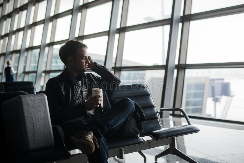 Portrait Of Young Handsome Man Wearing Casual Style Clothes Sitting On