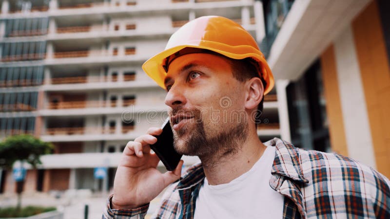Portrait of Young Handyman Making Call while Standing at Construction ...