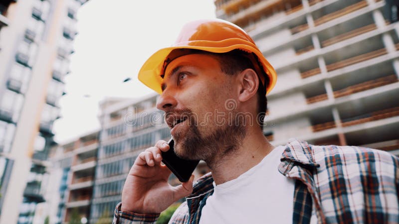 Portrait of Young Handyman Making Call while Standing at Construction ...