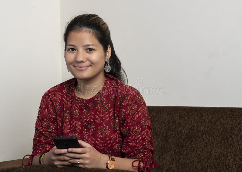 Portrait of a Young Indian Girl Using Her Mobile Phone while Looking ...