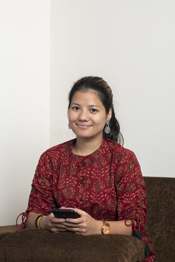 Portrait of a Young Indian Girl Using Her Mobile Phone while Looking ...