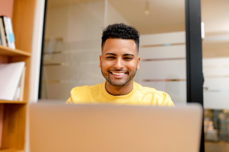 Portrait of Young Indian Man Using Laptop, Typing Messages, Web Surfing ...