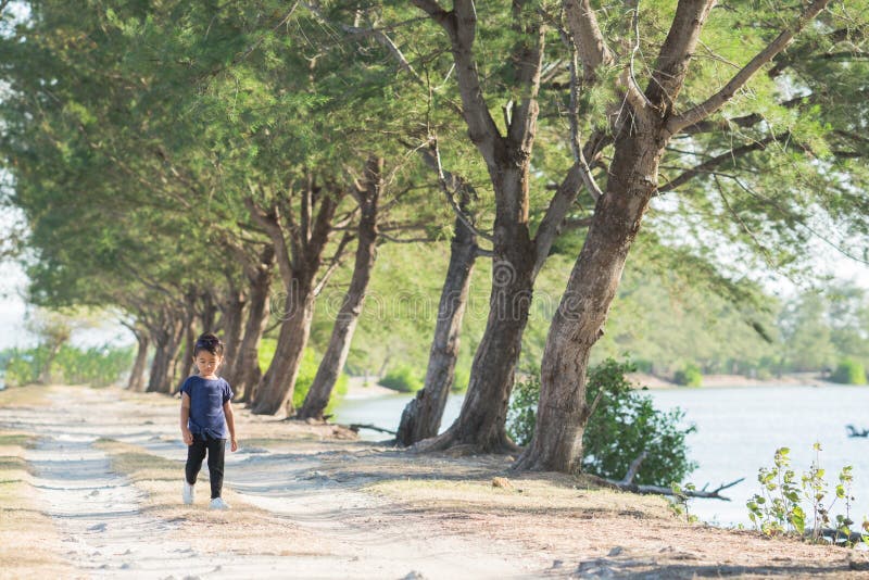 Kid Walking Alone between Trees Stock Photo - Image of nature, lonely ...