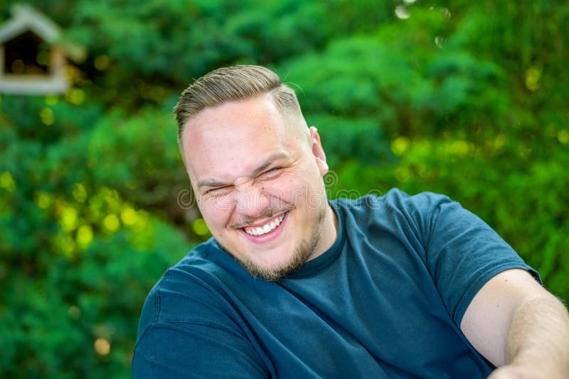 Portrait of a Young Man with a Beard Sitting in the Garden Stock Photo ...
