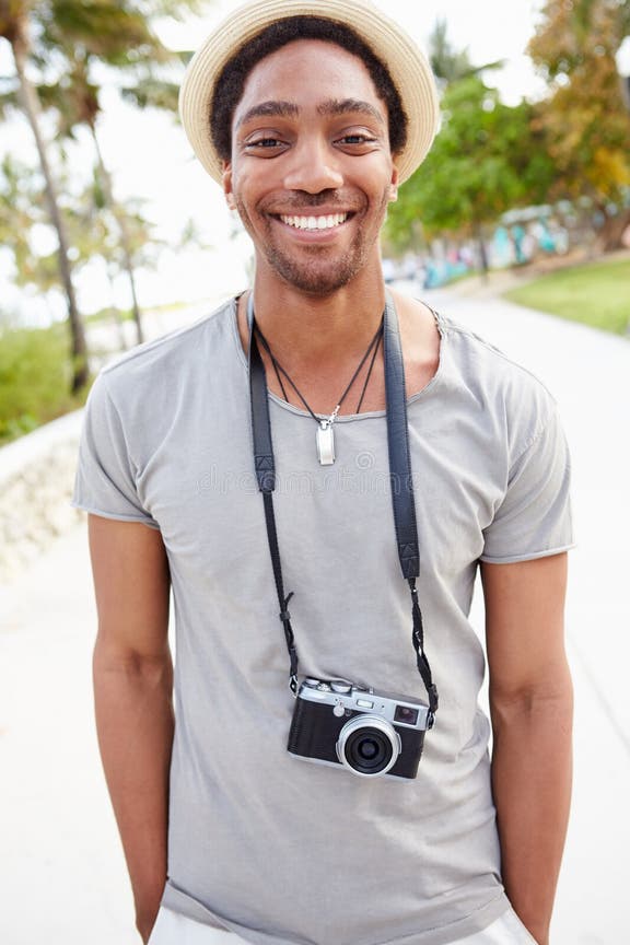Portrait of Young Man Carrying Camera Stock Photo - Image of holiday ...