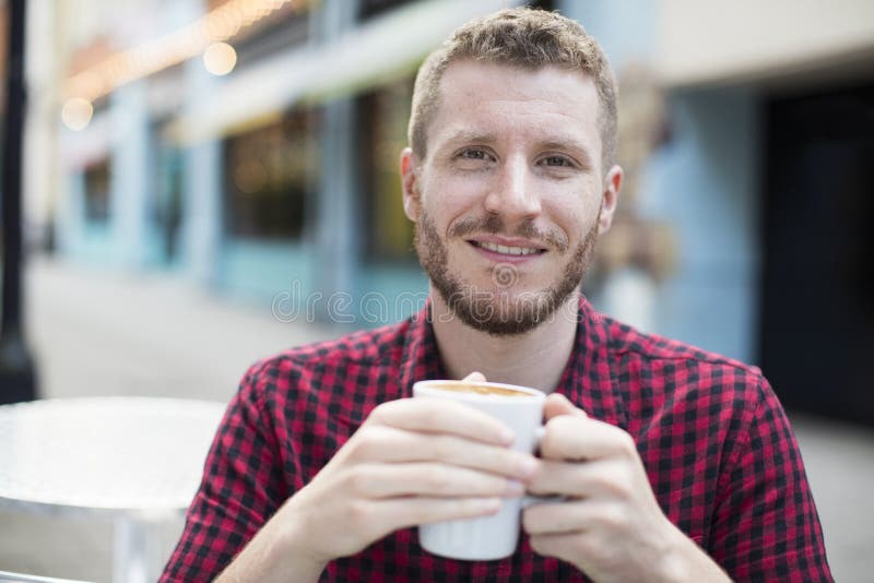 Portrait of Young Man Drinking Coffee at Outdoor Cafe Table Stock Photo ...
