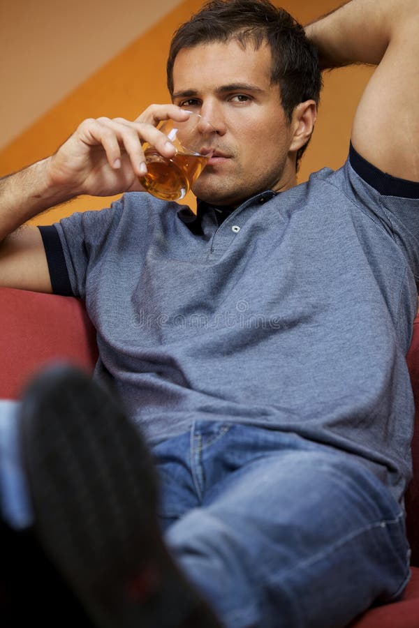 Portrait of Young Man Drinking Whisky in Hotel Room Stock Image - Image ...