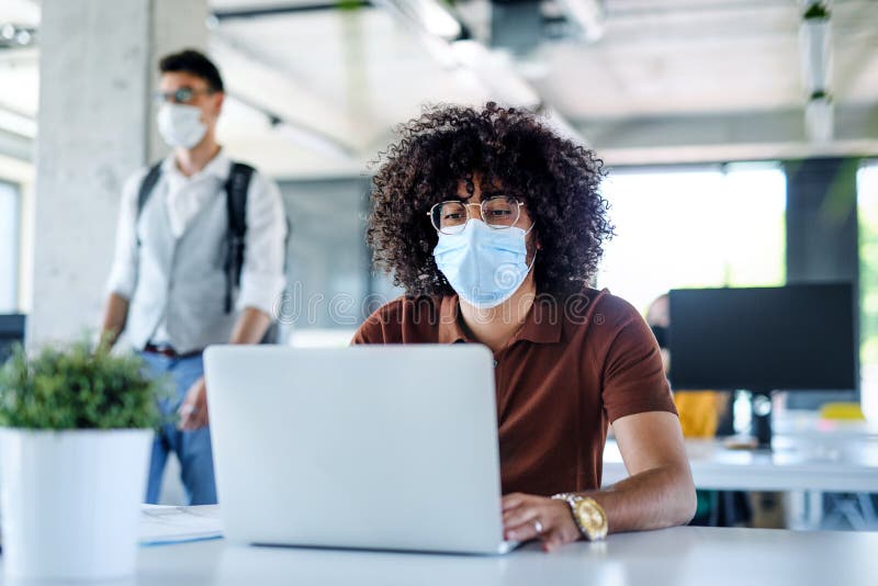 Portrait of Young Man with Face Mask Back at Work in Office after ...