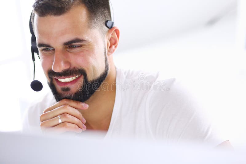 Portrait of a Young Man with a Headset in Front of a Laptop Computer ...