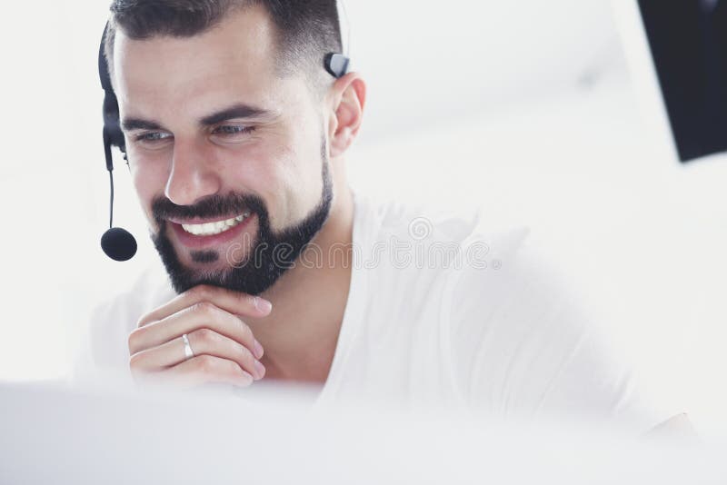 Portrait of a Young Man with a Headset in Front of a Laptop Computer ...
