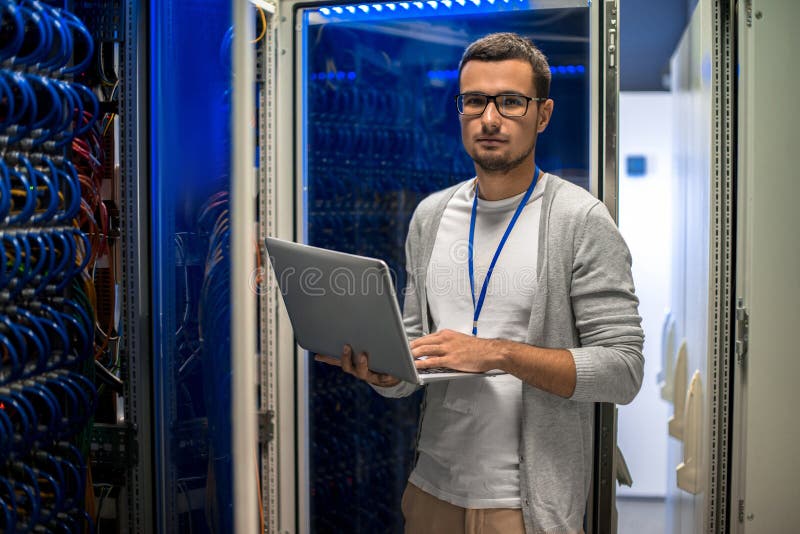 The engineer in datacenter stock image. Image of console - 17542505