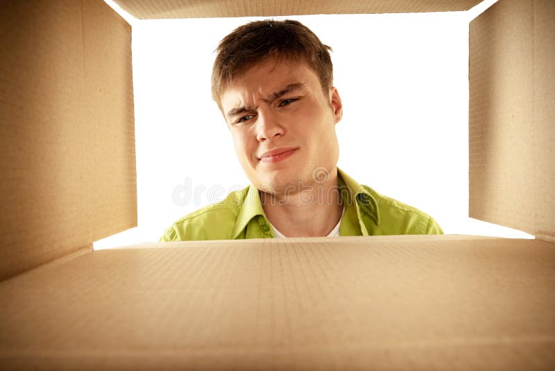Portrait of Young Man Looking into Open Cardboard Box with Unpleasant ...