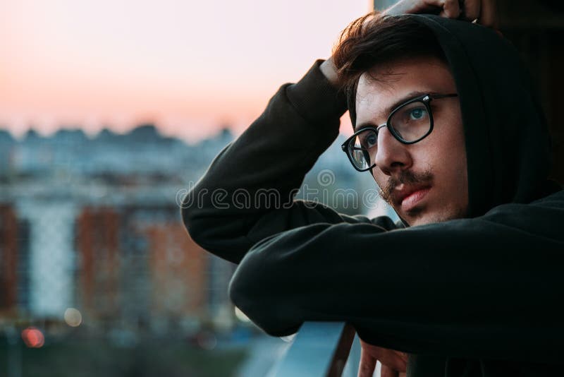 Portrait of a Young Man Looking at Sunset from a Balcony Stock Image ...