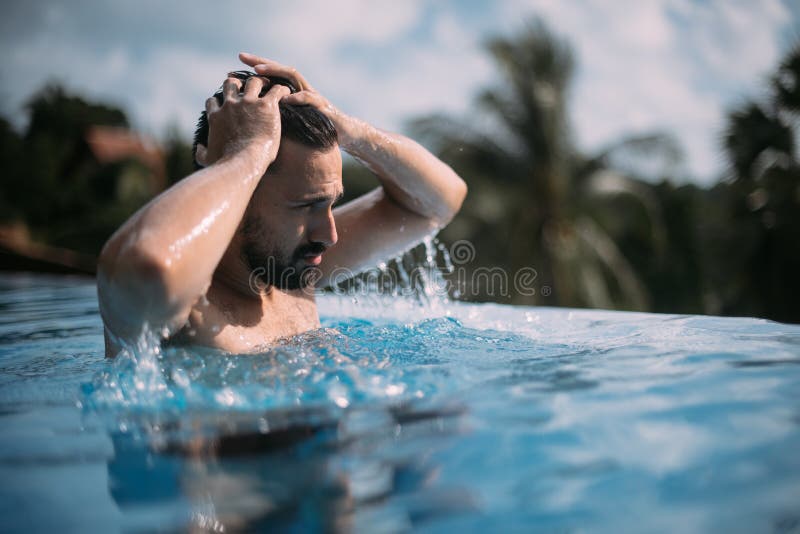Portrait of a Young Man in an Outdoor Pool. Attractive Guy with a Beard ...