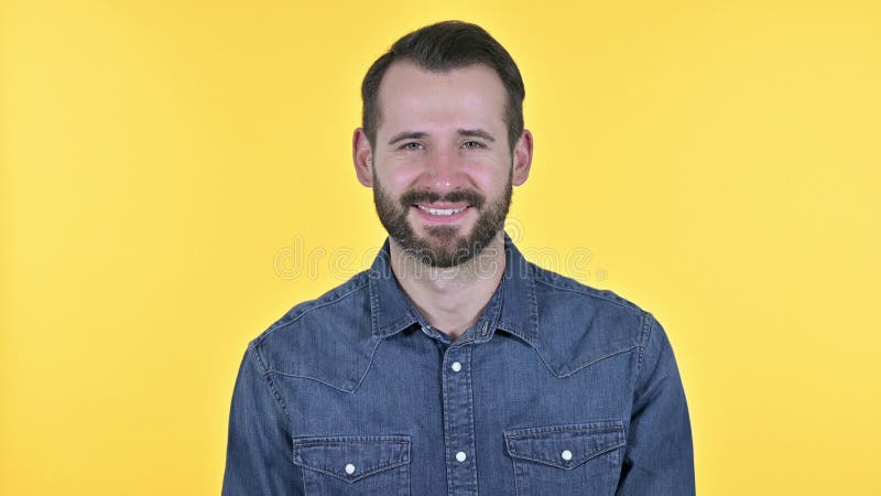 The Portrait of Young Man Saying Yes by Shaking Head, Yellow Background ...