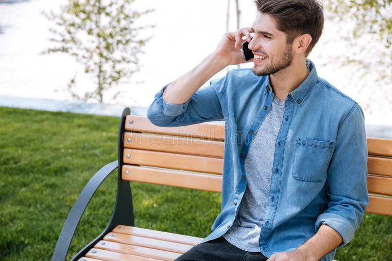Portrait of a Young Man Sitting on the Bench Talking Stock Image ...