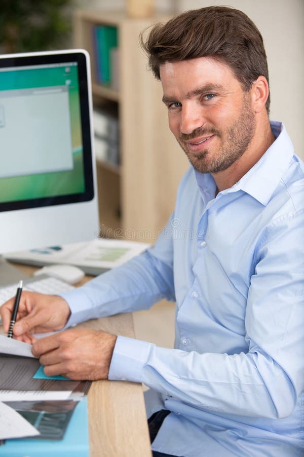 Portrait Young Man Sitting at Desk Stock Image - Image of professional ...