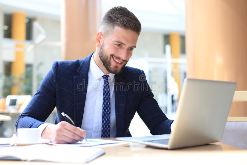 Portrait of Young Man Sitting at His Desk in the Office Stock Image ...