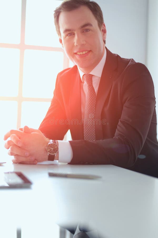 Portrait of Young Man Sitting at His Desk in the Office. Stock Photo ...