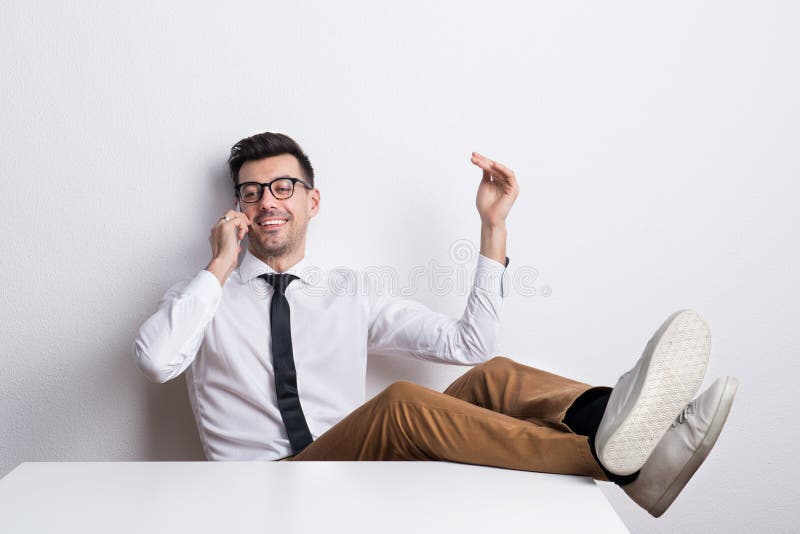 Portrait of a Young Man with Smartphone in a Studio, Making a Phone ...