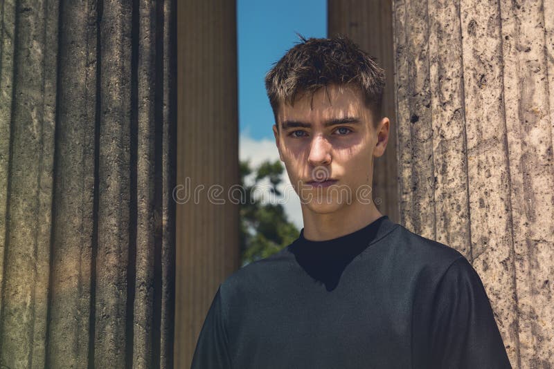 Young Man Standing between Ancient Columns Stock Photo - Image of ...