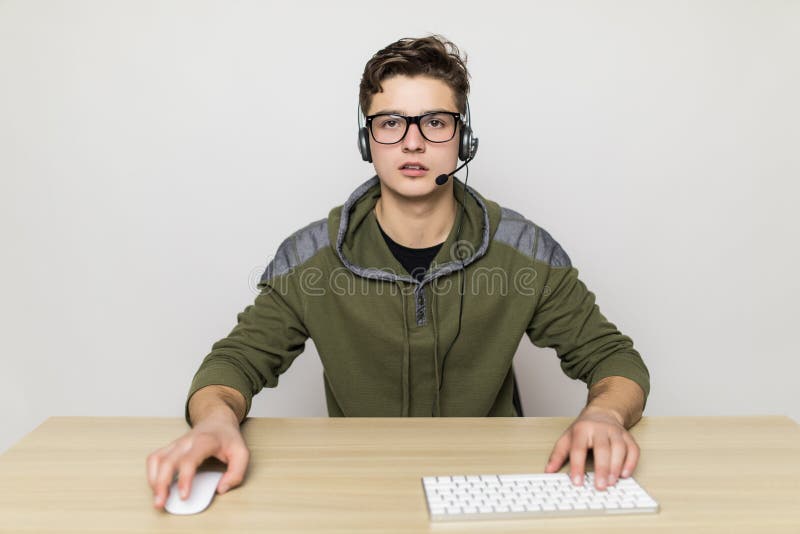 Portrait of Young Man at Table with Hands on Keyboard and Mouse. Front ...