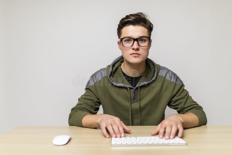 Portrait of Young Man at Table with Hands on Keyboard and Mouse. Front ...