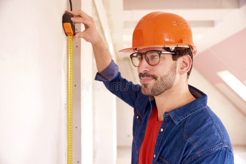 Repairman Using Measuring Tape Stock Photo - Image of person, project ...