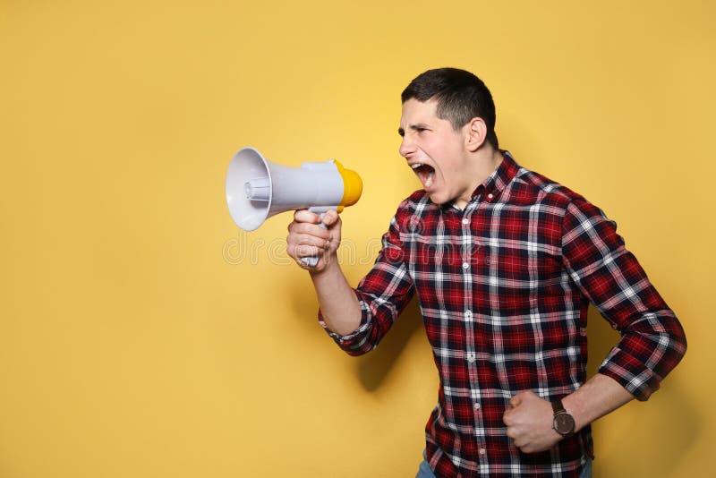 Portrait of Young Man Using Megaphone on Color Background Stock Image ...