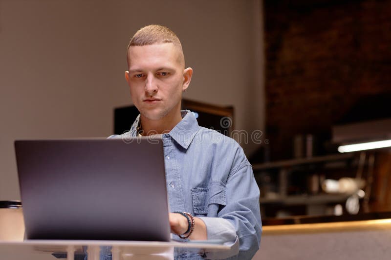 Portrait of Young Man Working on Laptop in Modern Office Stock Photo ...