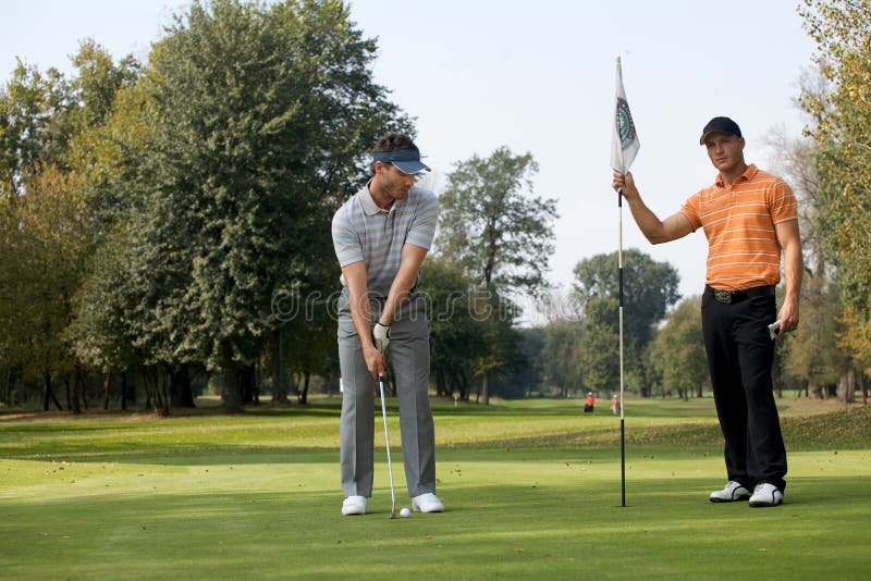 Portrait of Young Men Standing with Golf Sticks on Golf Course Stock ...