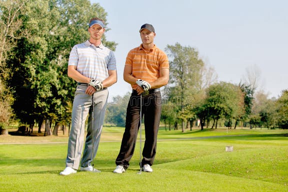Portrait of Young Men Standing with Golf Sticks on Golf Course Stock ...