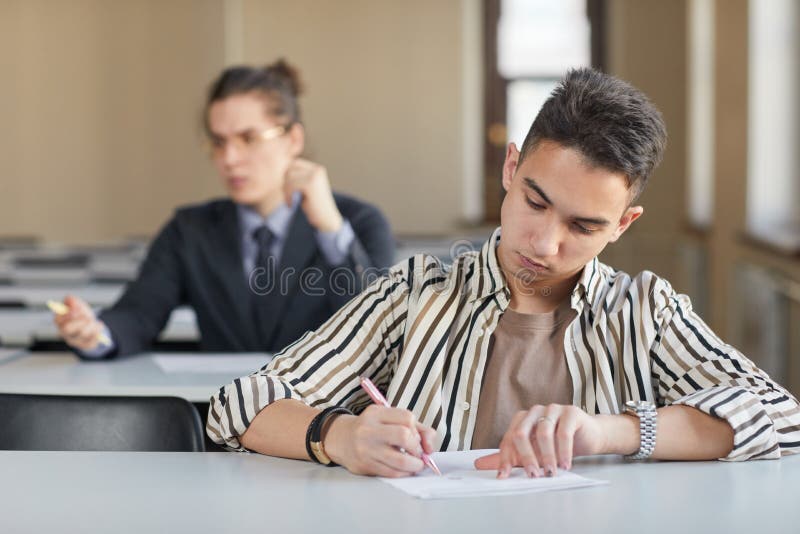 Man taking exam in college stock image. Image of reading - 217729275