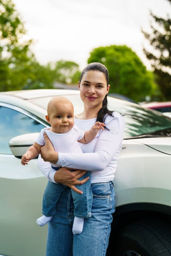 Portrait of Young Mom with Child in Front of Car Stock Image - Image of ...