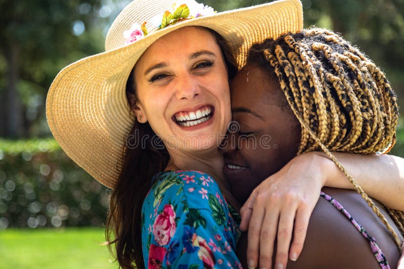 Young Multiracial Couple Of Gay Women Take Selfie And Kiss On The Cheek