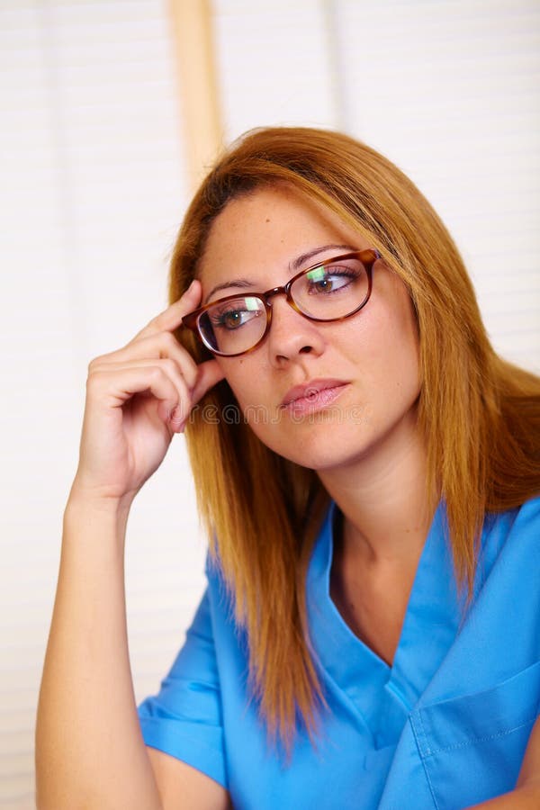 Pretty Nurse Smiling with a Call Me Gesture Stock Image - Image of blue ...
