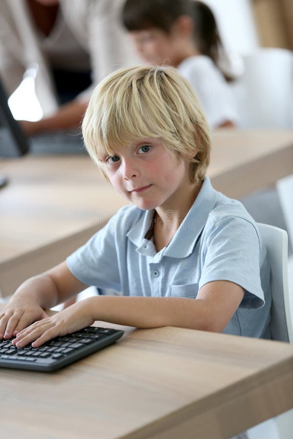 Portrait of Young Pupil Boy Using Computer Stock Photo - Image of years ...